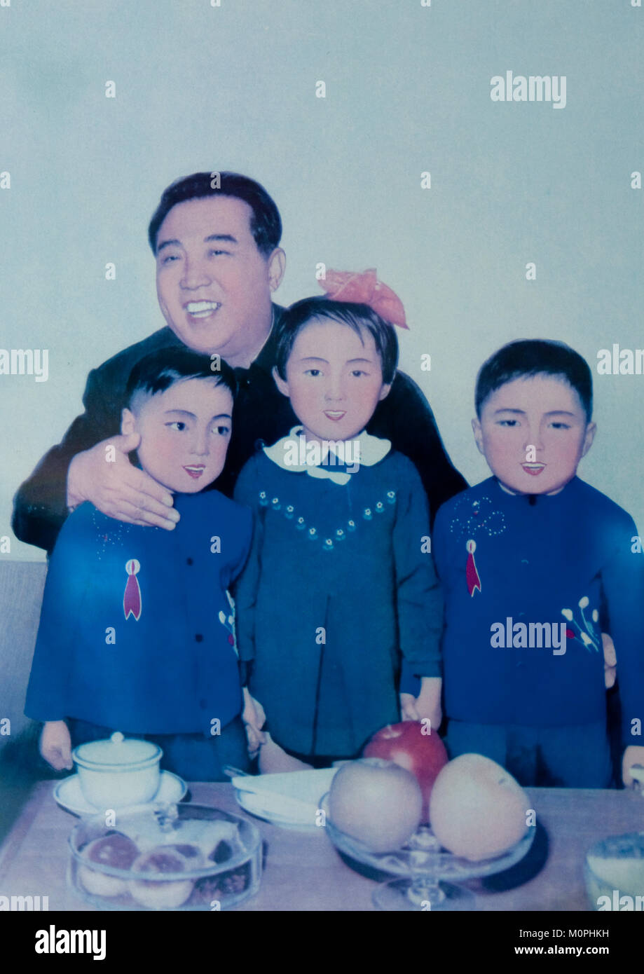 Kim il Sung with triplets on a propaganda poster in Tchang Gwang school ...