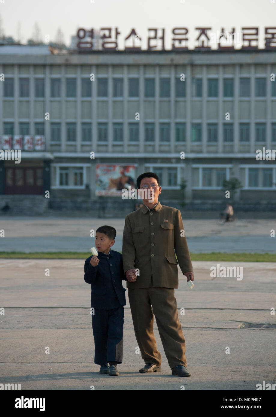 North Korean father and son eating an ice cream in the main square ...