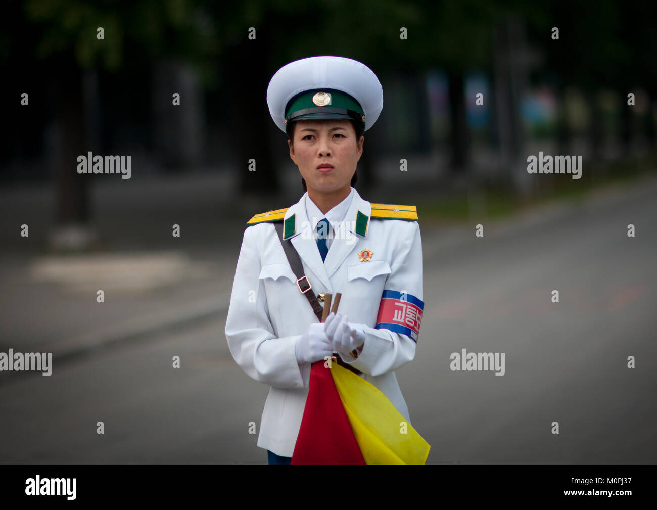 North Korean female traffic security officer in white uniform in the ...