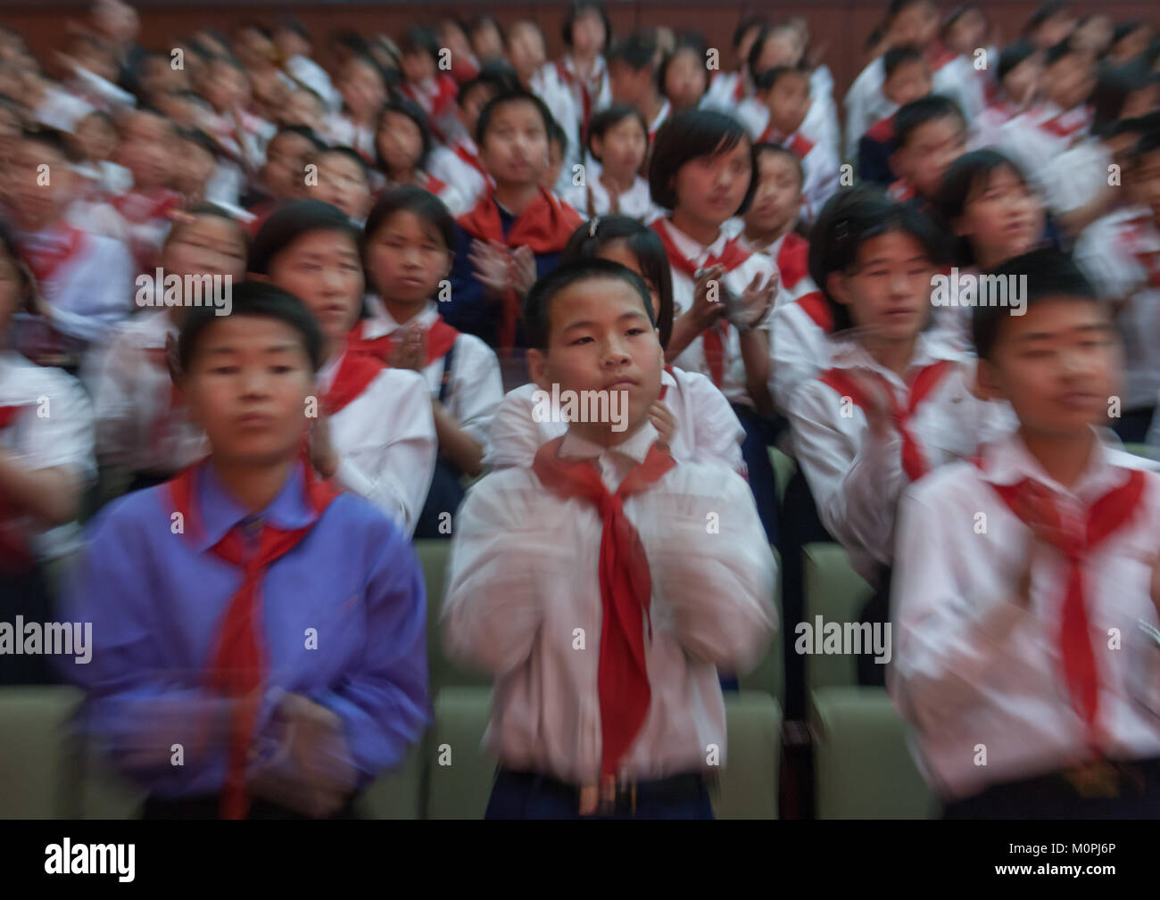 Crowd of North Korean teenage spectators applauding in the Mangyongdae ...
