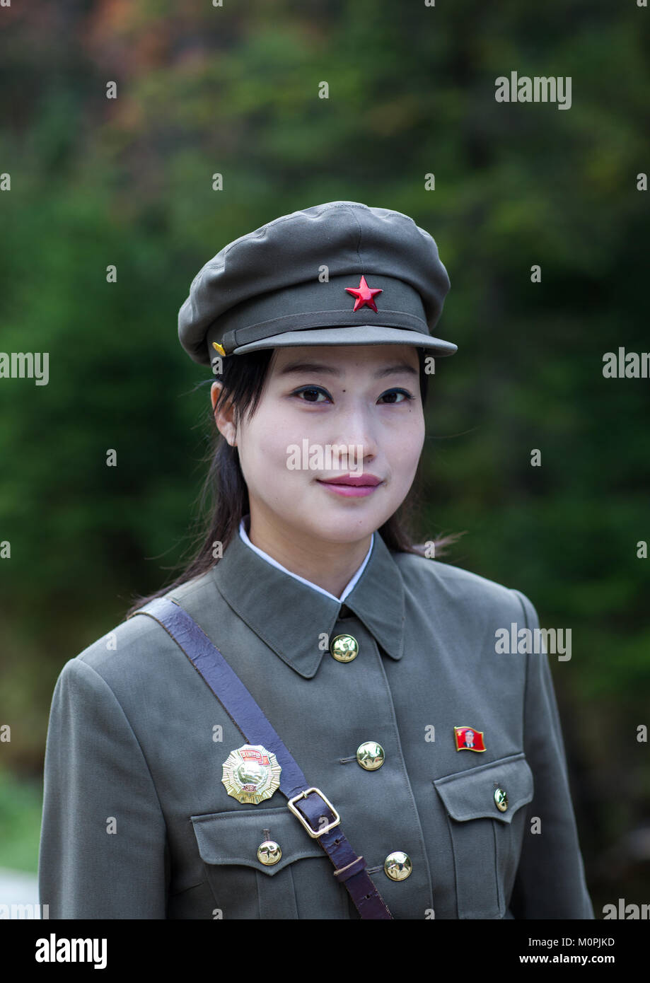 Portrait of a cute North Korean guide in military style uniform ...