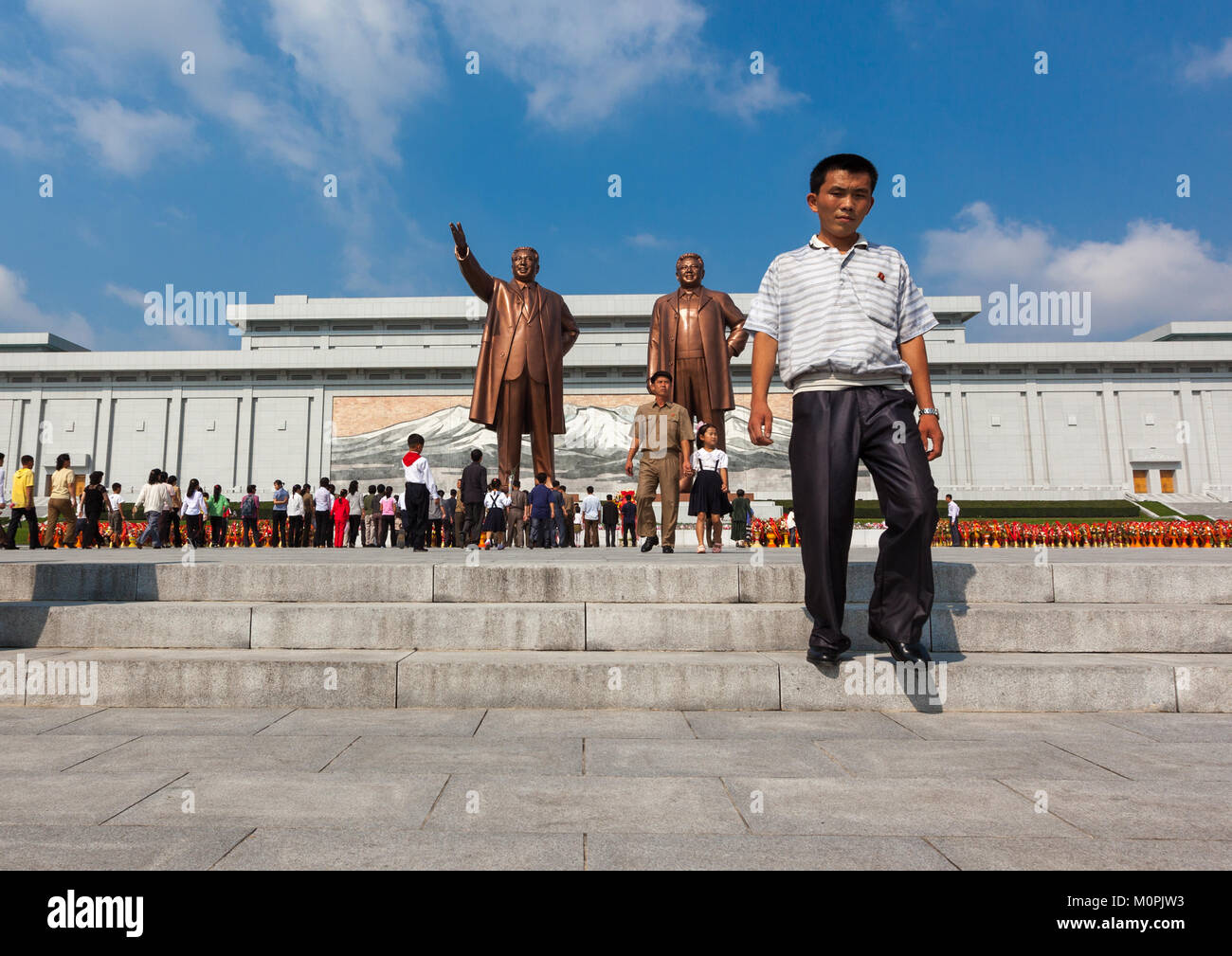 North Korean people in front of the statues of the Dear Leaders in ...