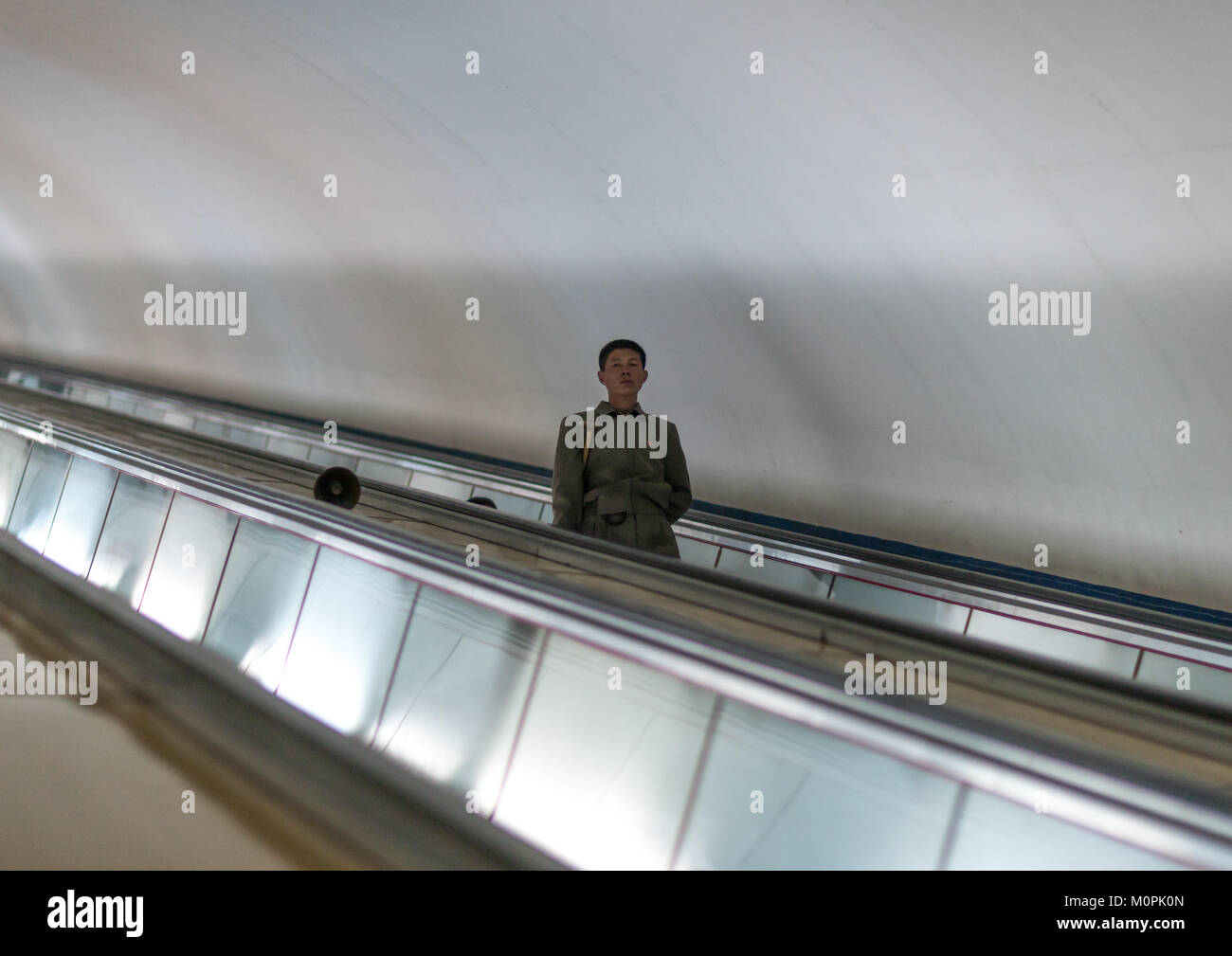 North Korean people using escalator leading to the subway station ...