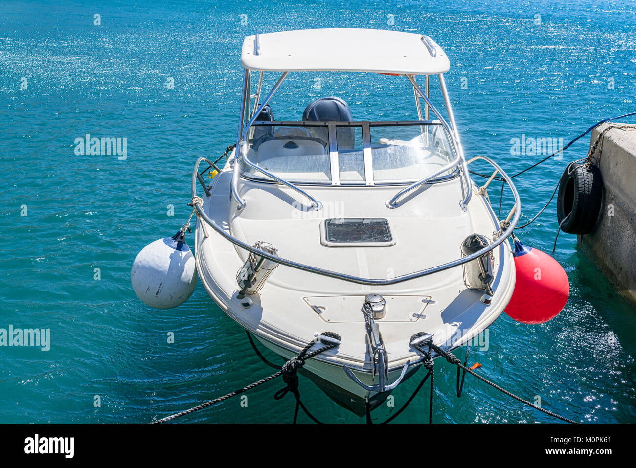 small yacht docking in a harbor Stock Photo - Alamy