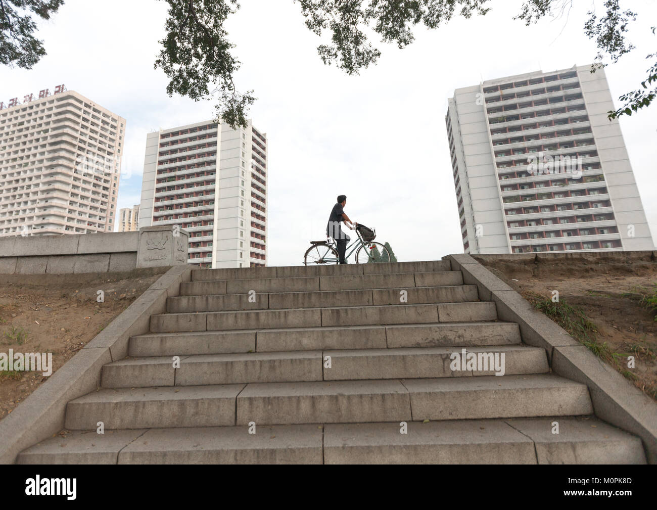 North Korean man riding a bicycle in the city, Pyongan Province ...