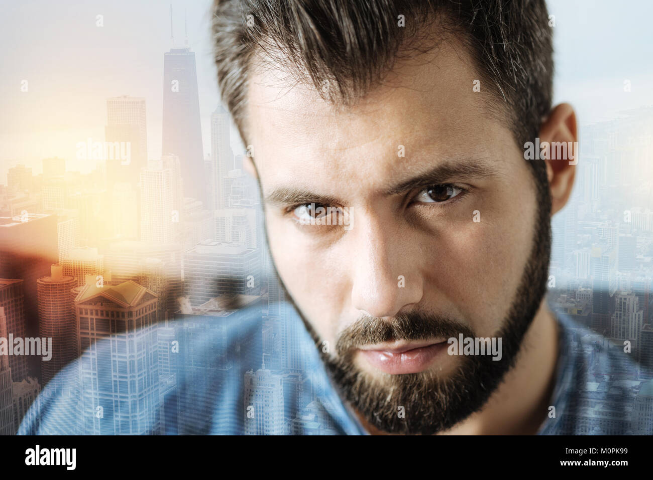 Serious handsome man concentrating and looking straight Stock Photo - Alamy