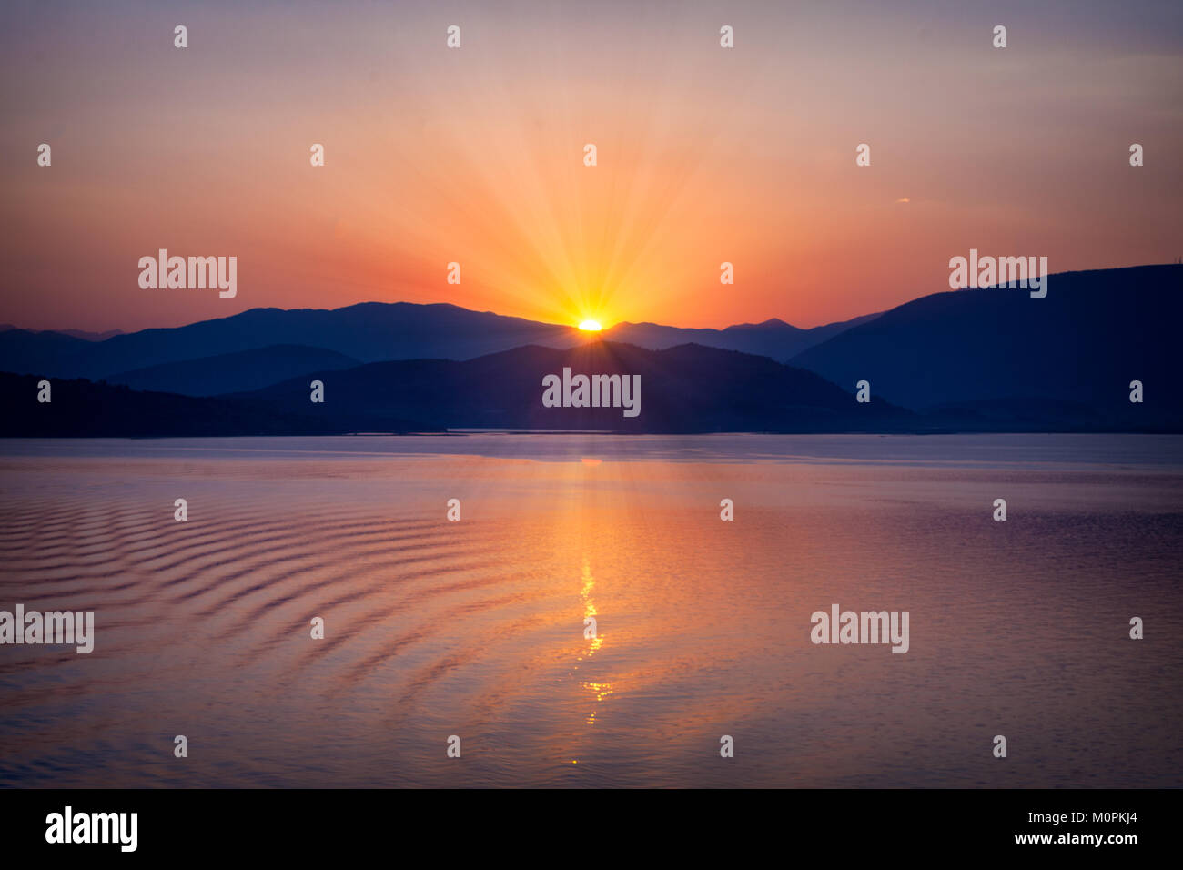 Beautiful sunset over the ocean. Sunrise in the sea, Greece islands ...