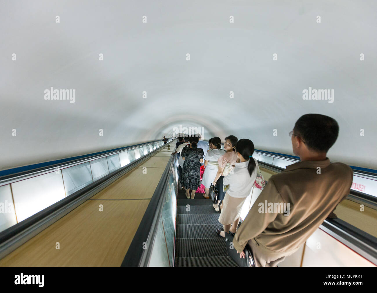 North Korean people using escalator leading to the subway station ...