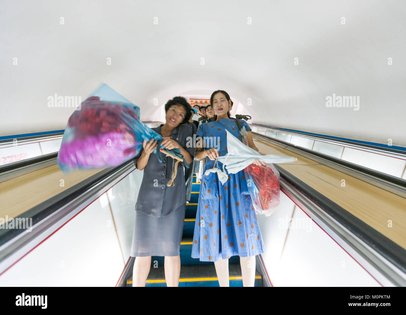 North Korean people using escalator leading to the subway station ...