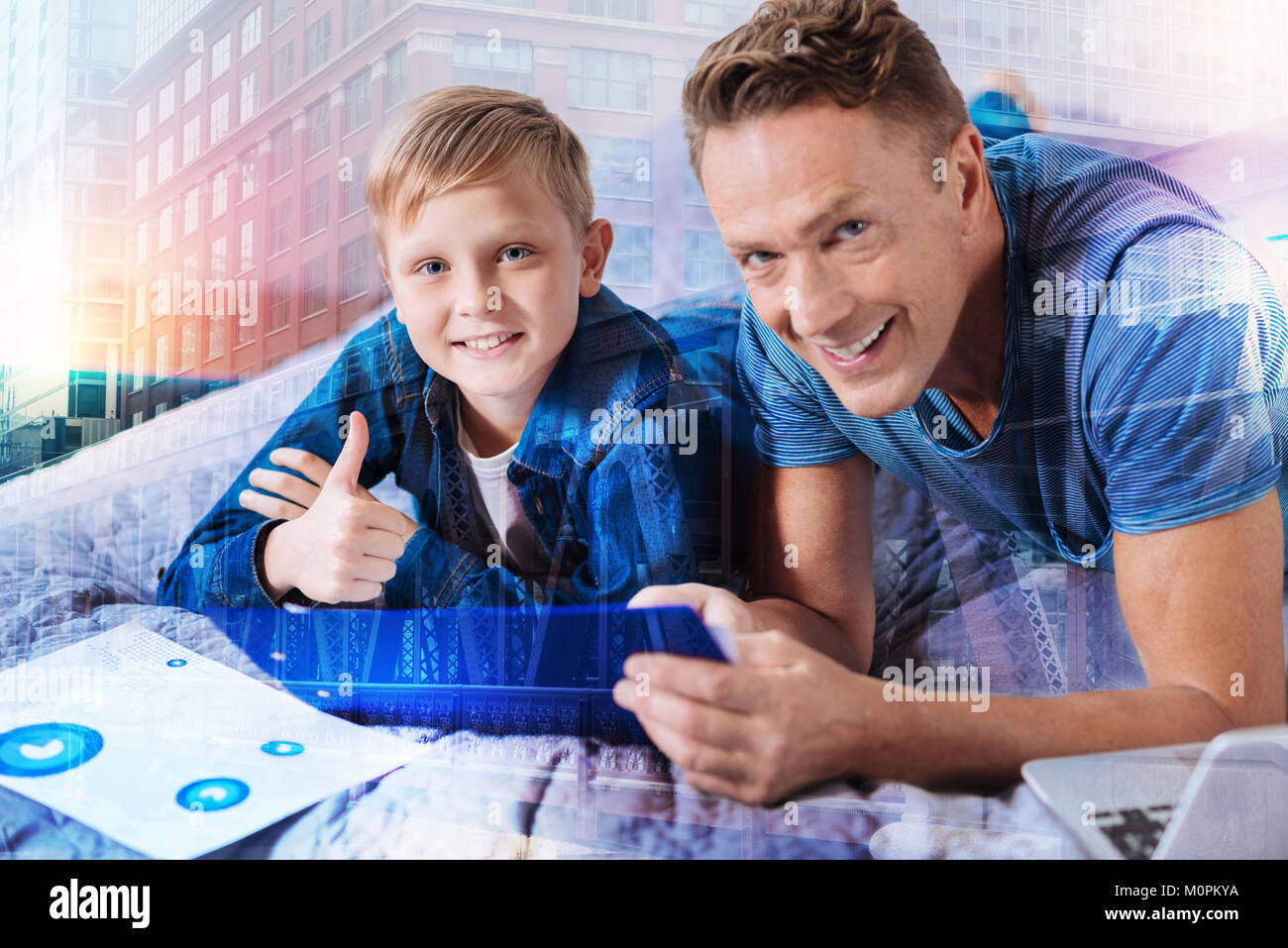 Satisfied boy raising his thumb up Stock Photo - Alamy