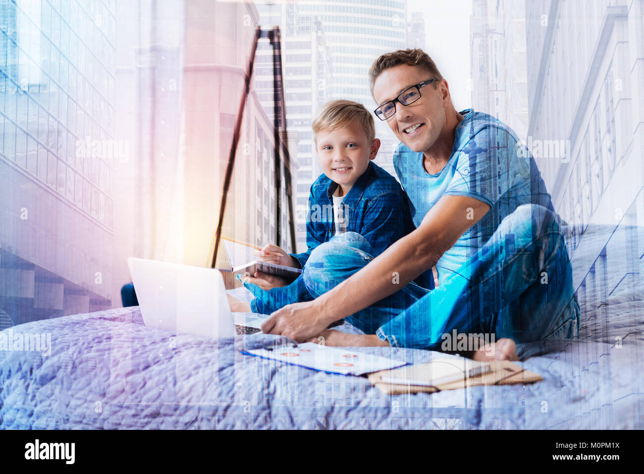 Joyful blonde boy making notes Stock Photo - Alamy