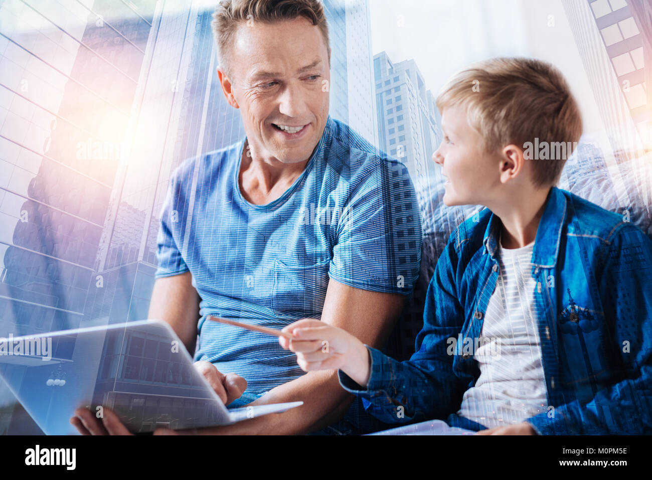 Attractive male person looking at his son Stock Photo - Alamy