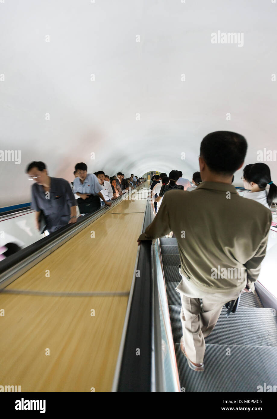 North Korean people using escalator leading to the subway station ...