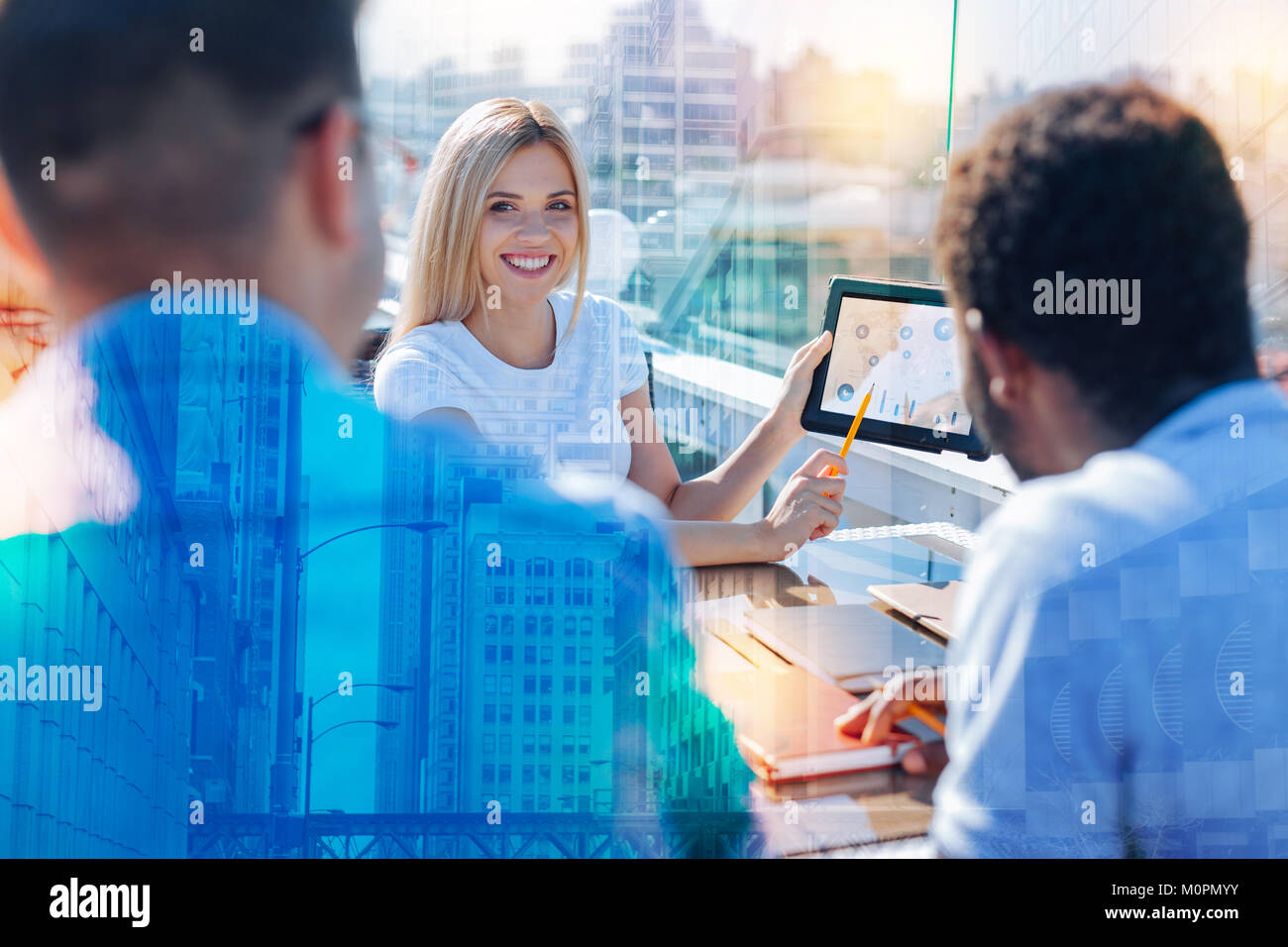Adorable girl showing her presentation to friends Stock Photo - Alamy