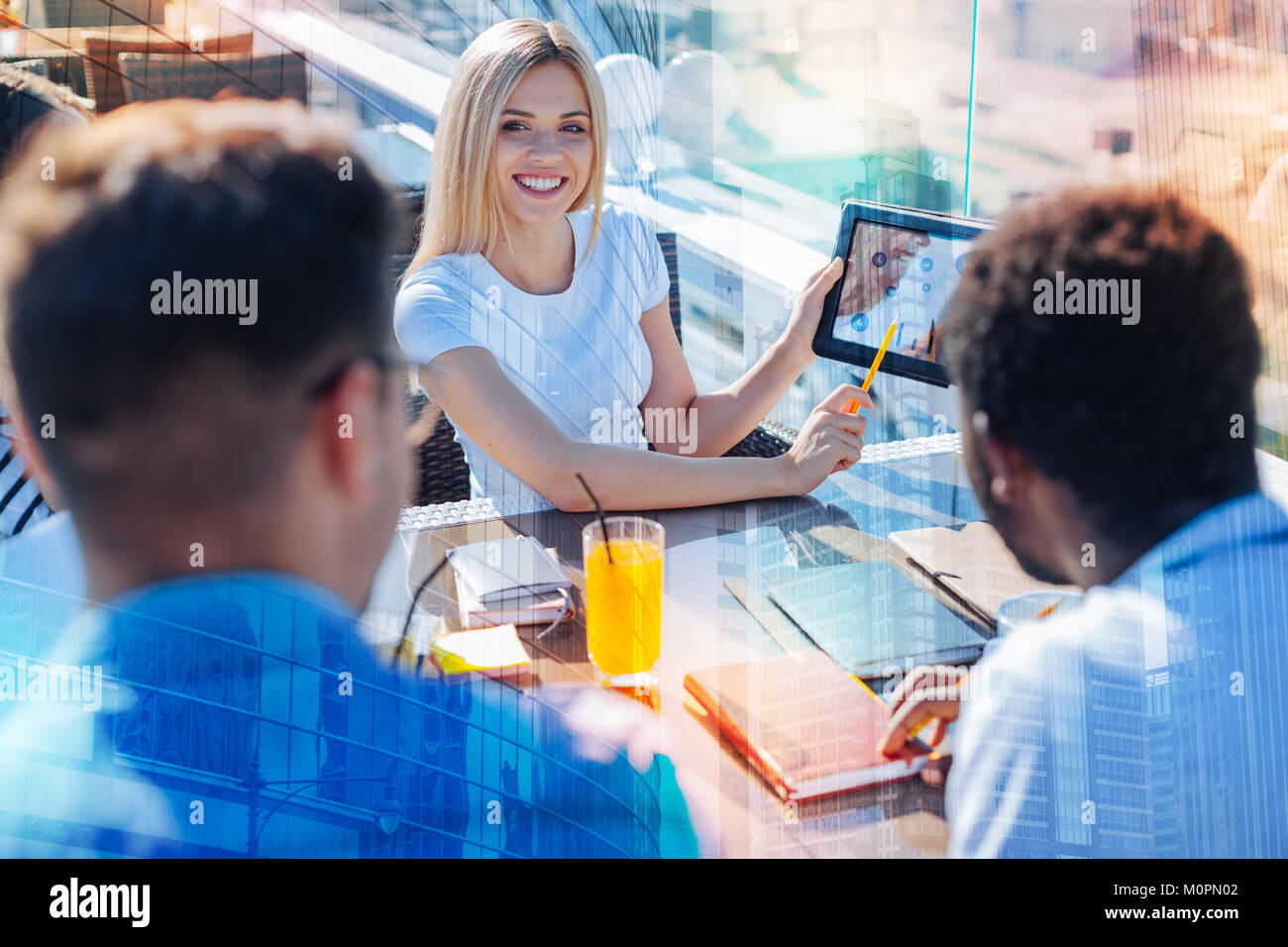 Positive student explaining complicated graphic to her friends Stock ...