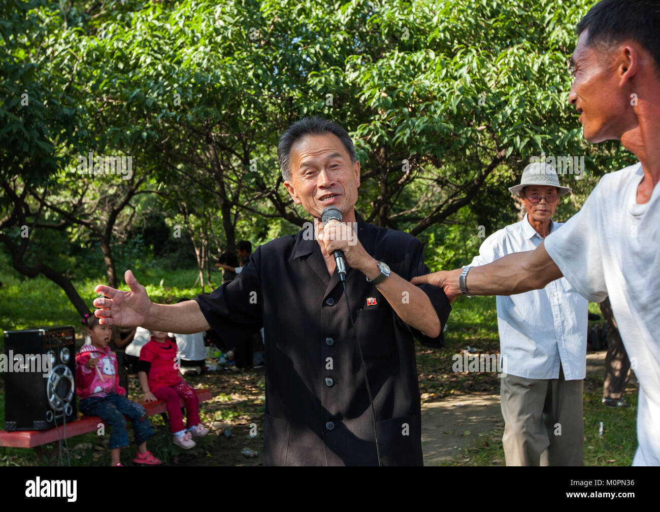 North Korean men singing in a park on national day, Pyongan Province ...