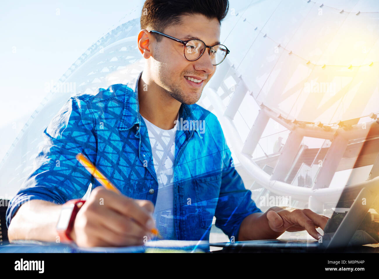 Smiling man working on his project Stock Photo - Alamy