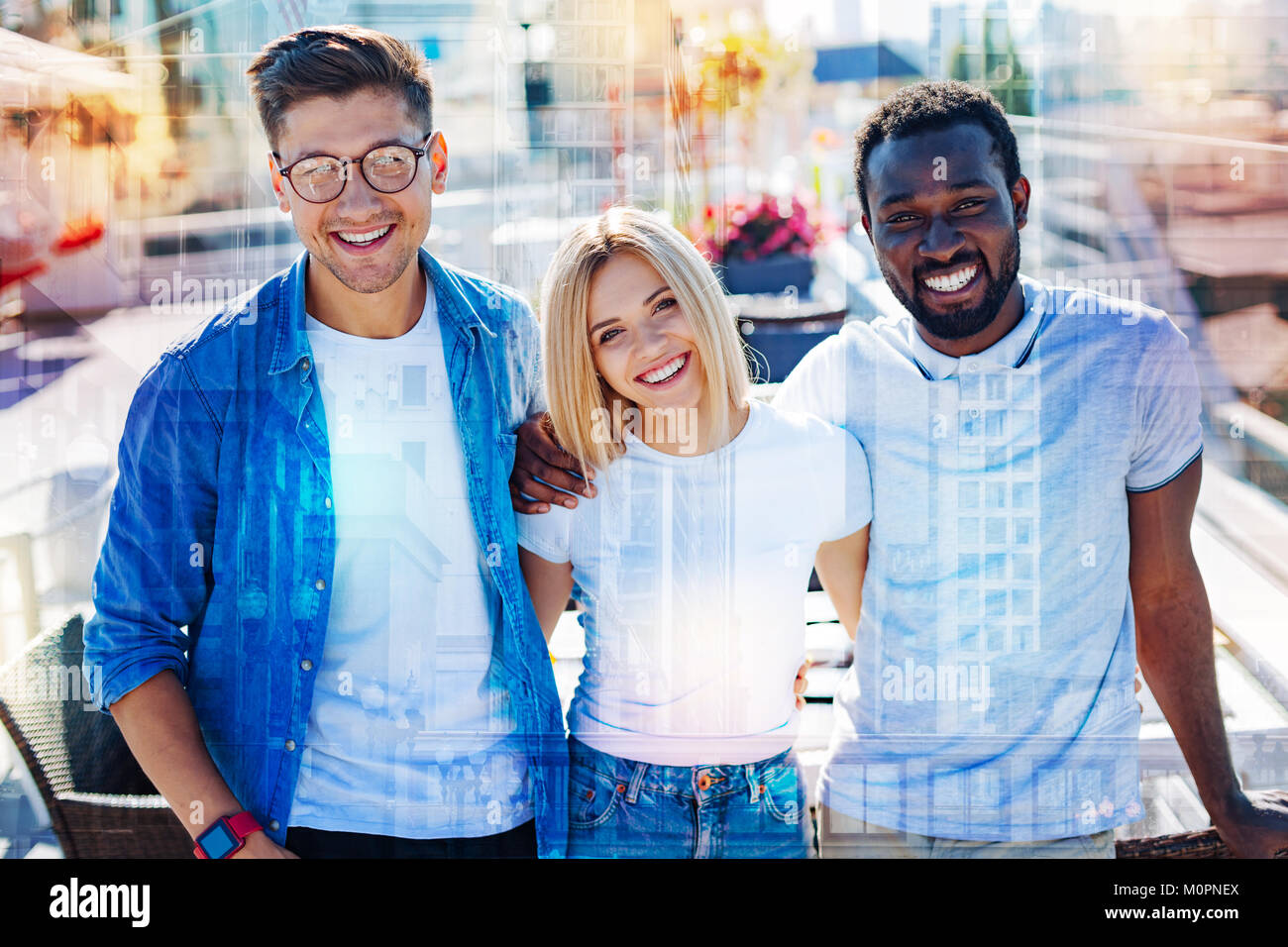 Happy colleagues smiling and standing together Stock Photo - Alamy