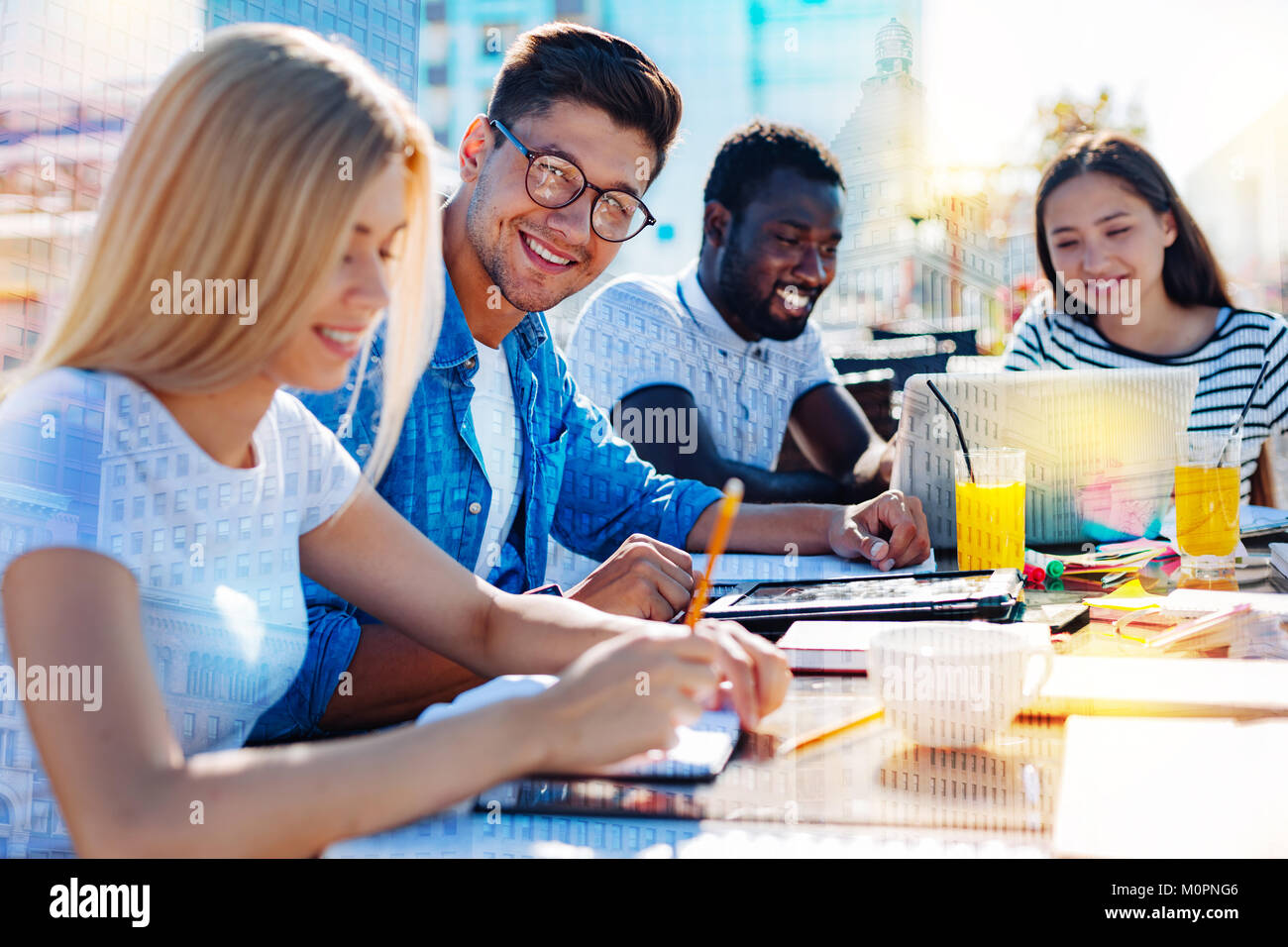 Joyful man working in a team Stock Photo - Alamy