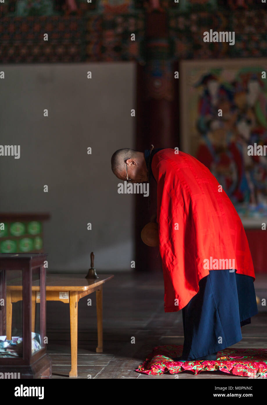 North Korean monk praying in Pohyon-sa Korean buddhist temple, Hyangsan ...