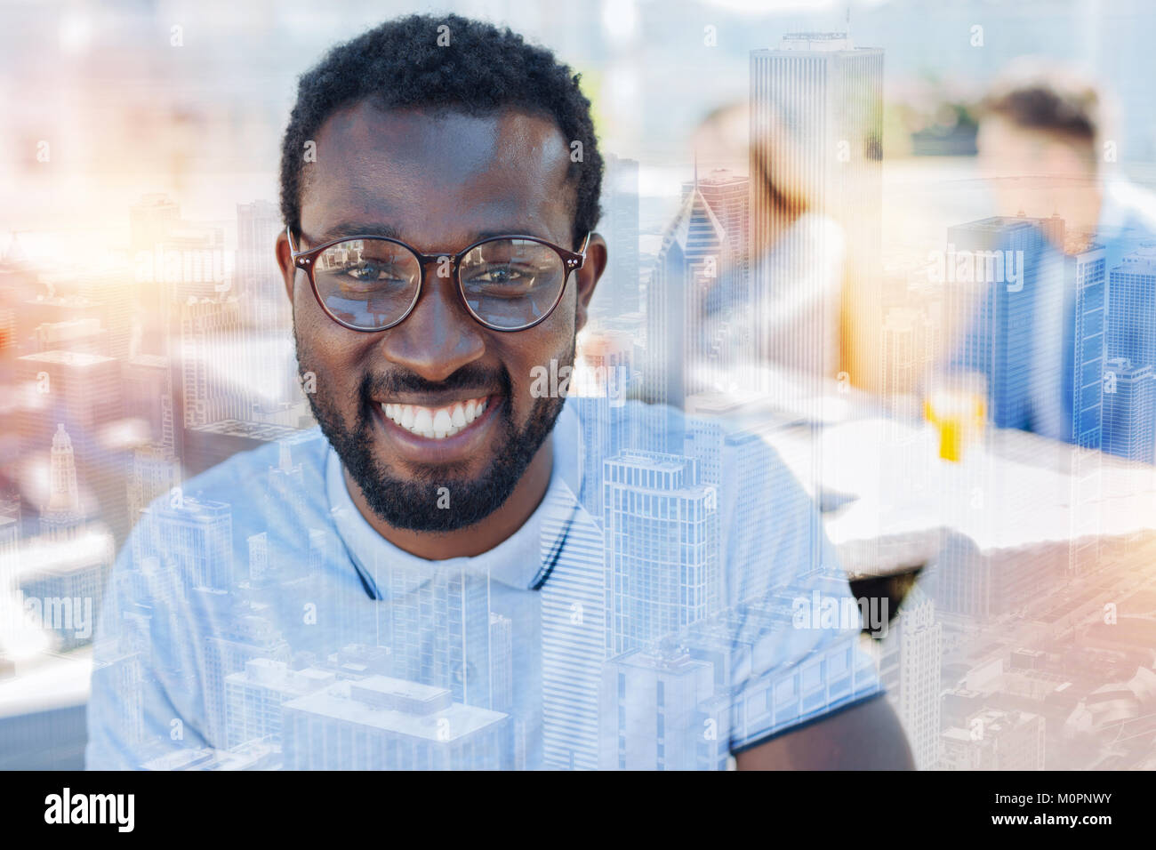 Positive delighted brunette keeping smile on his face Stock Photo - Alamy