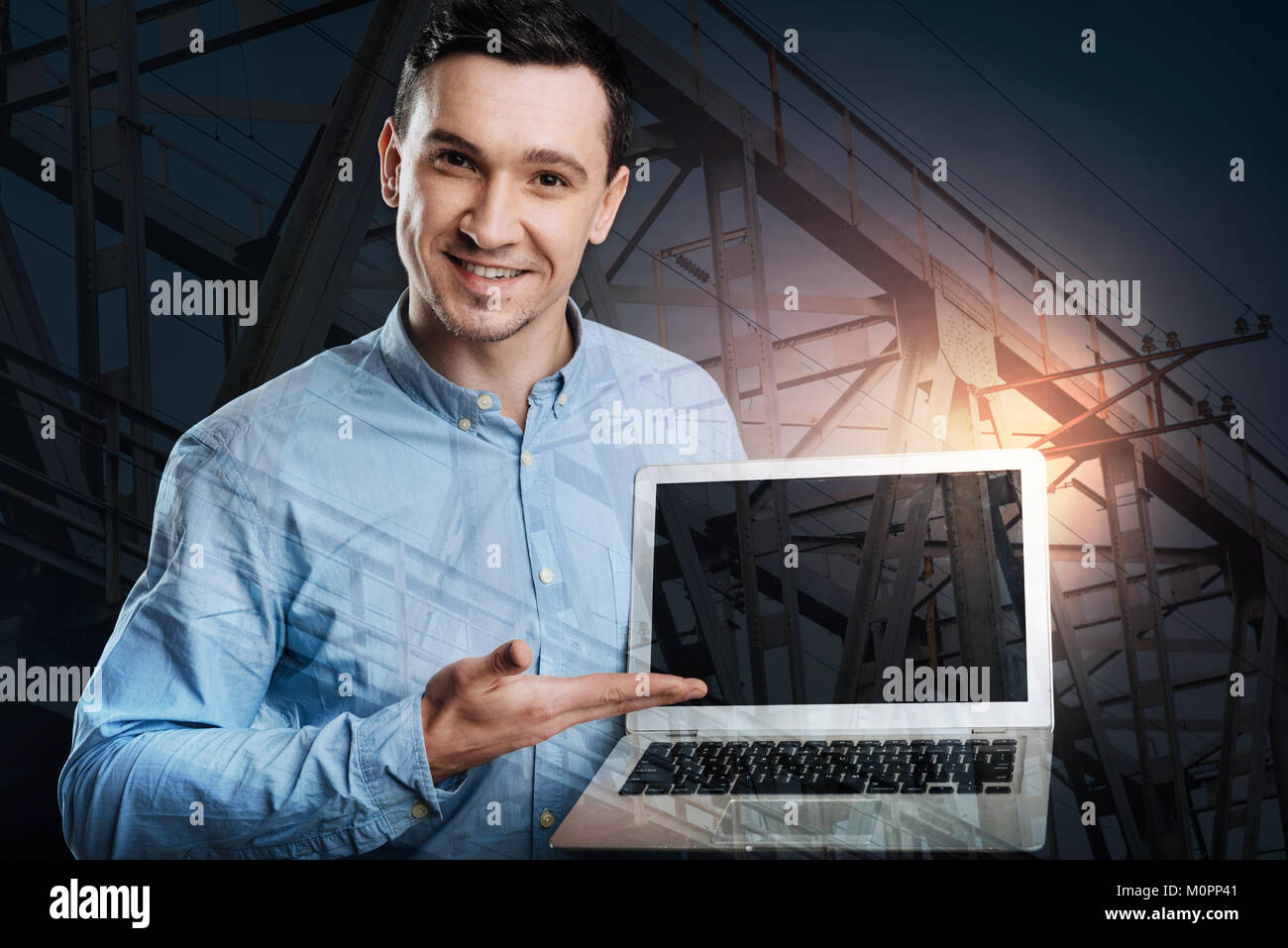 Friendly businessman pointing toward screen of laptop Stock Photo - Alamy