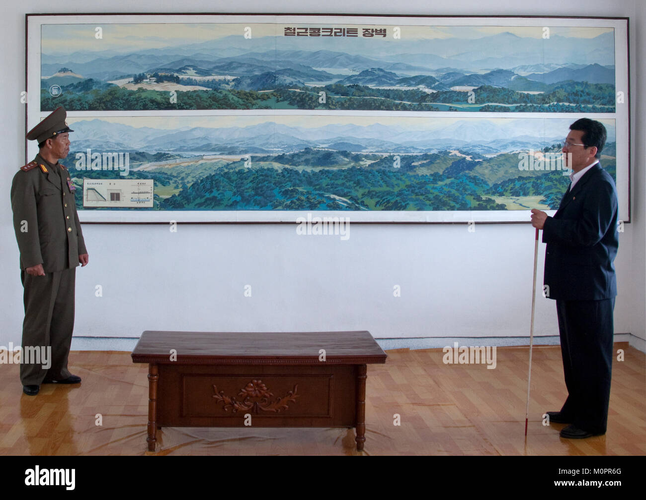 North Korean colonel and a guide in front of the map of the ...