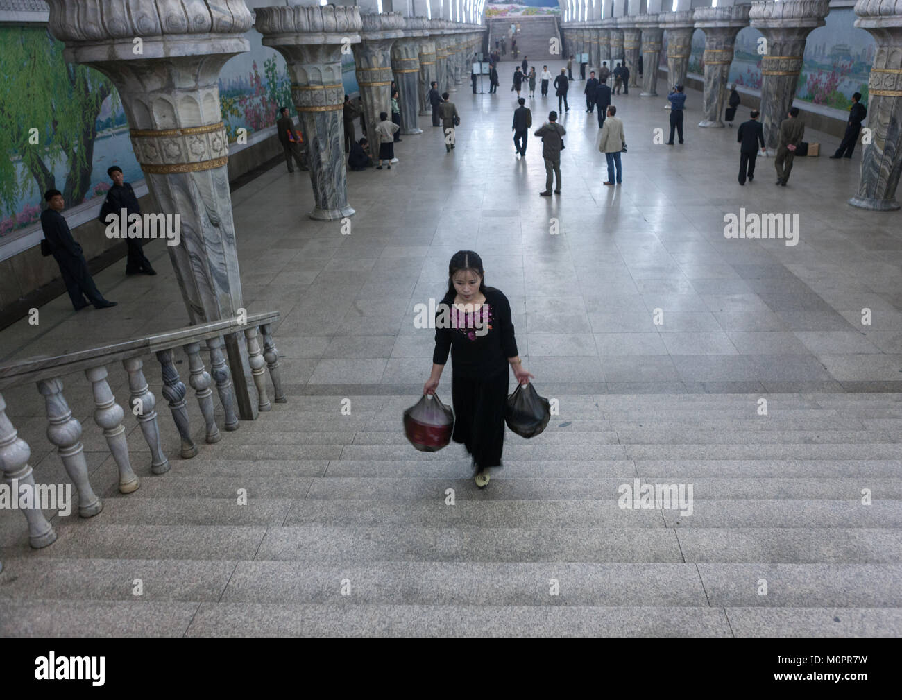 Young North Korean woman climbing stairs in Yonggwang station, Pyongan ...