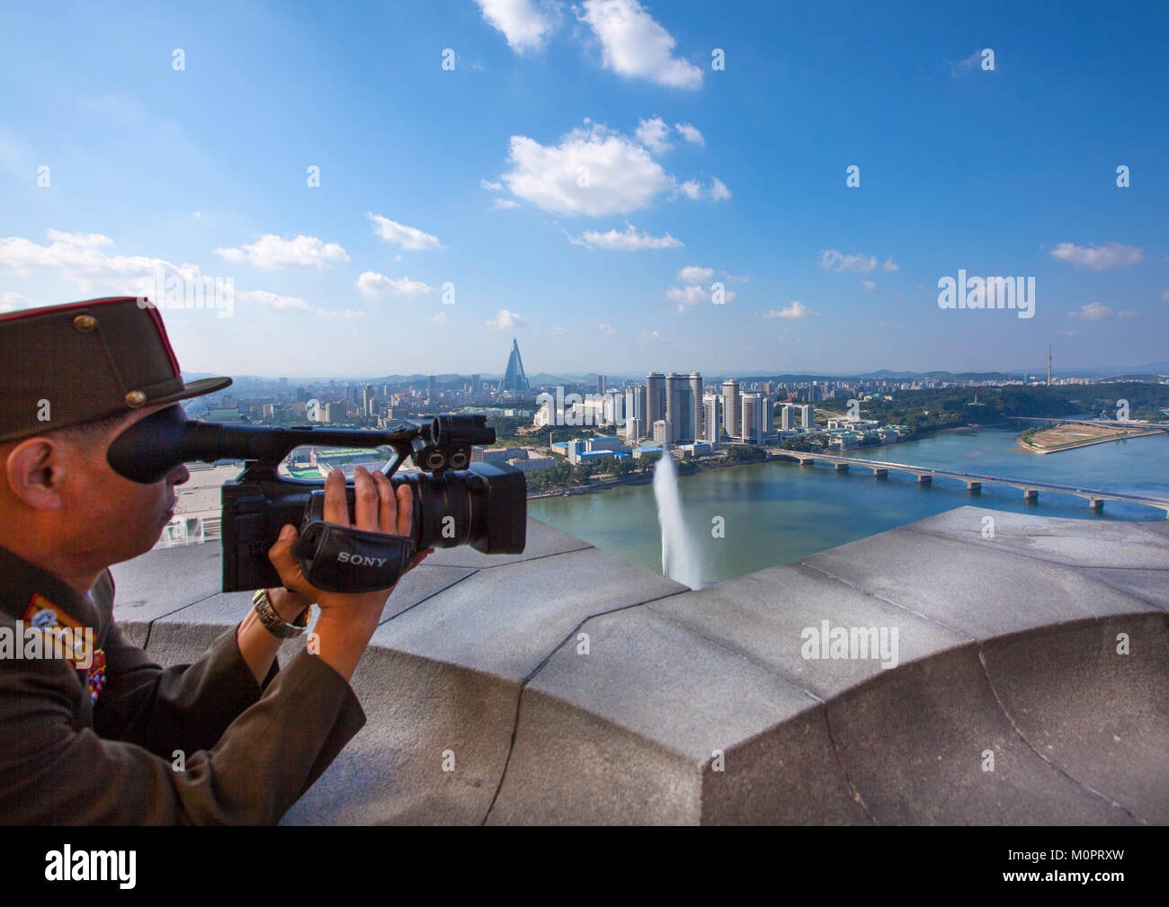 North Korean soldier filming the city from the top of Juche tower ...