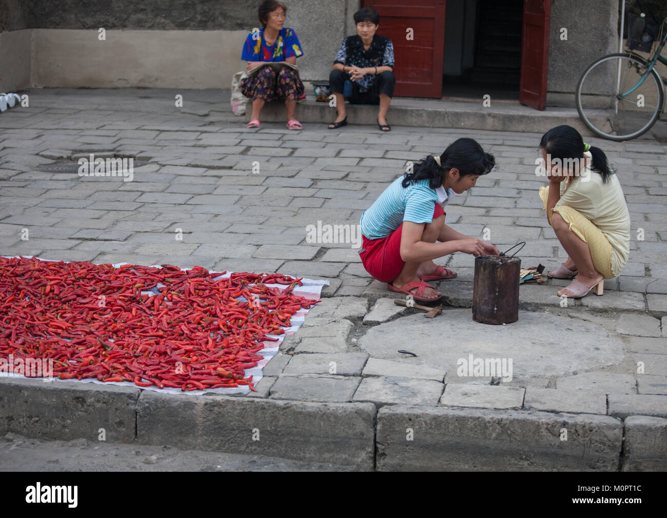 North Korean women sit near dried kimchi, Pyongan Province, Pyongyang ...