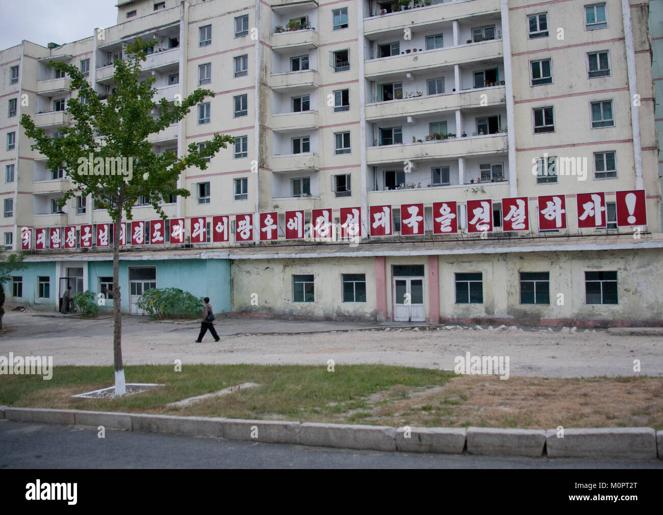 Run down apartment blocks with a propaganda billboard, North Hwanghae ...