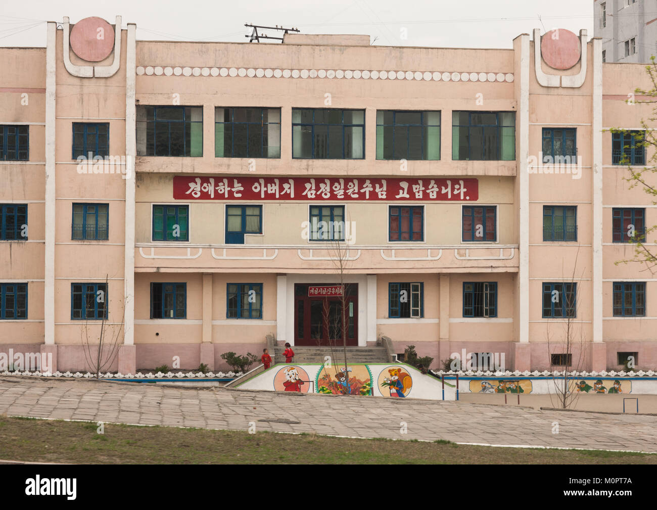 Kindergarten building with a propaganda slogan saying Dear father ...