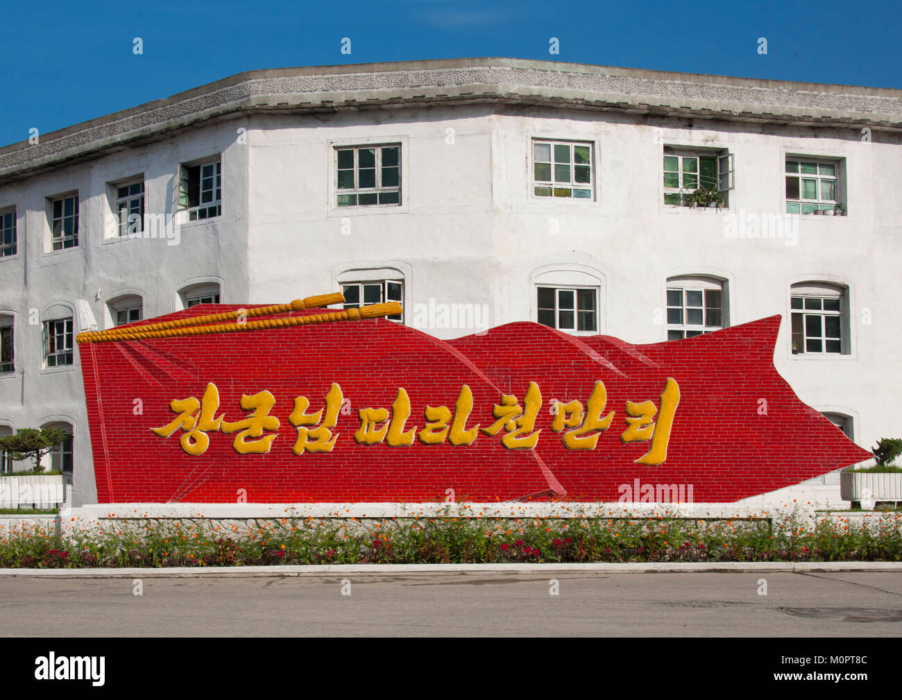 Propaganda slogan in front of apartment block, North Hamgyong Province ...