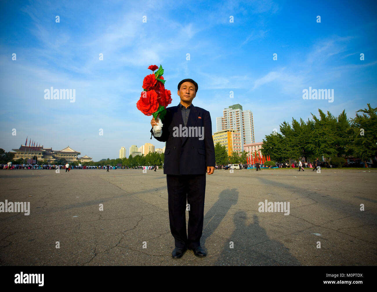 North Korean man with plastic flowers during the september 9 parade ...