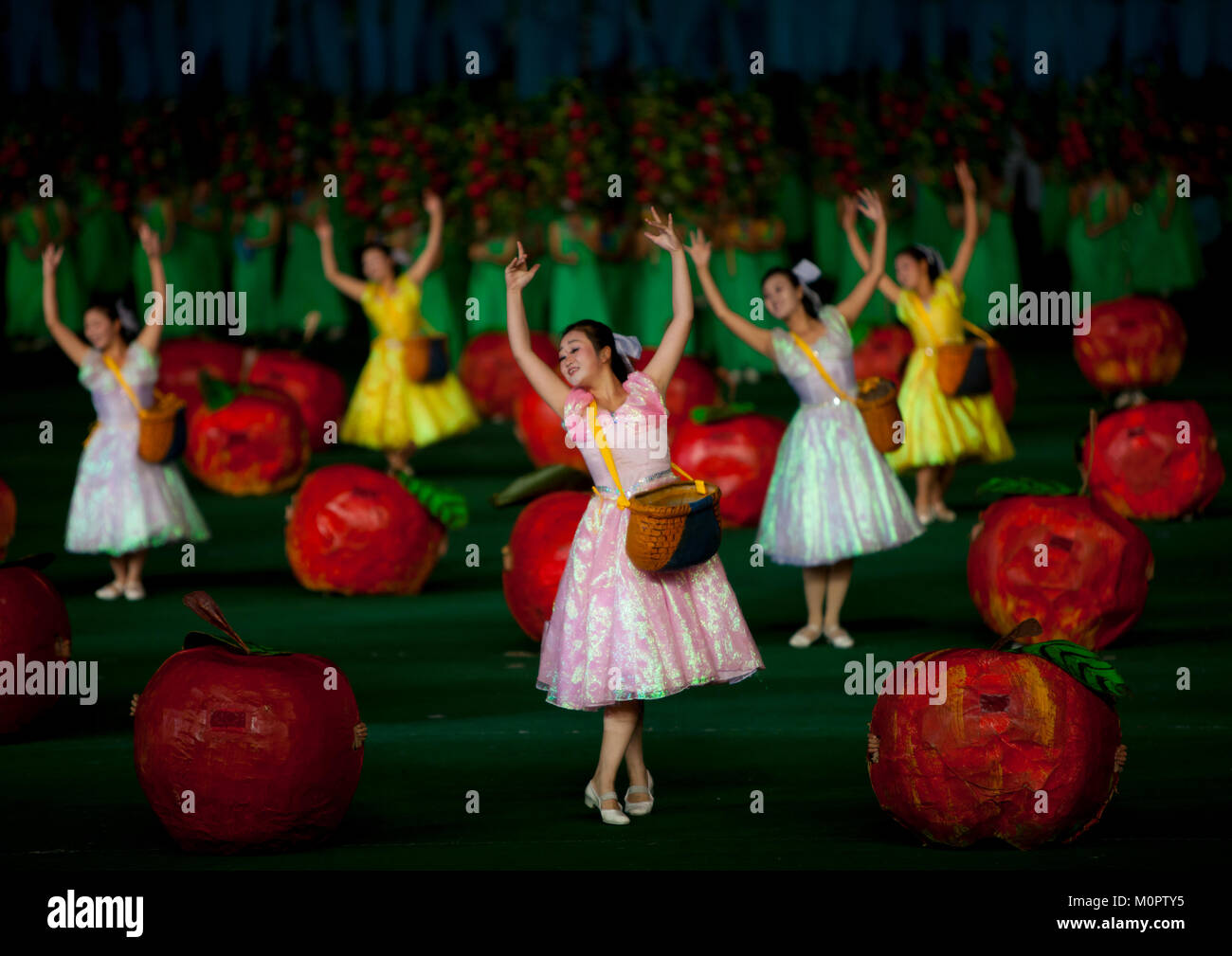 Women dancing between apples at Arirang mass games in may day stadium ...