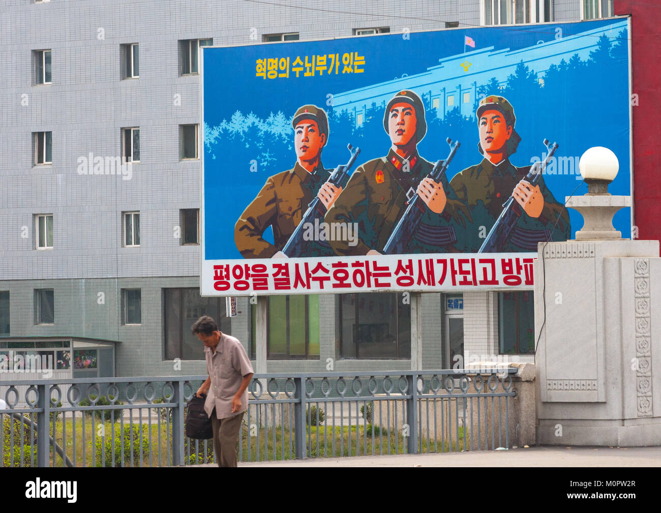 Propaganda billboard in the street with North Korean soldiers, Pyongan ...