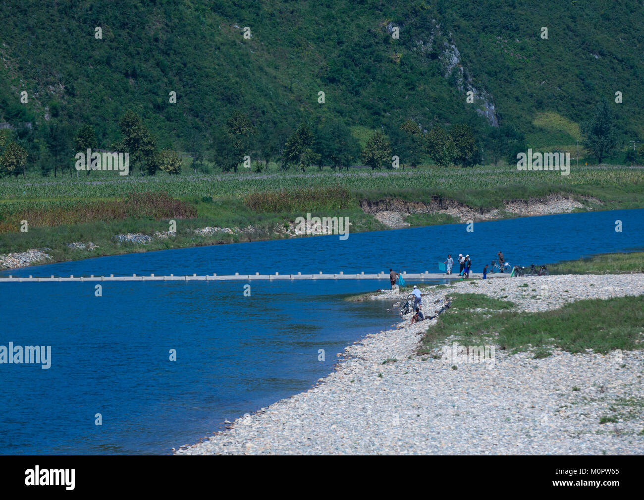 North Korean people crossing a river on a bridge, Pyongan Province ...