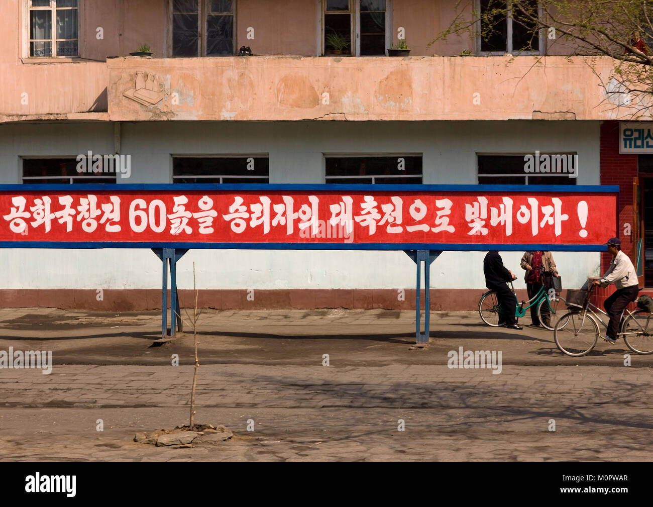 Propaganda slogan on a red billboard in town, South Pyongan Province ...