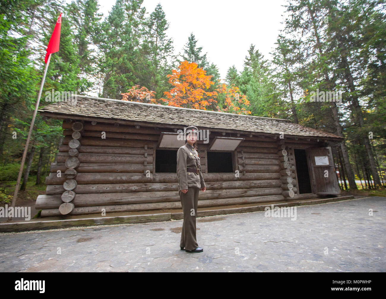 Tourist guide in front of a log cabin in the secret camp no.1 hq of the ...