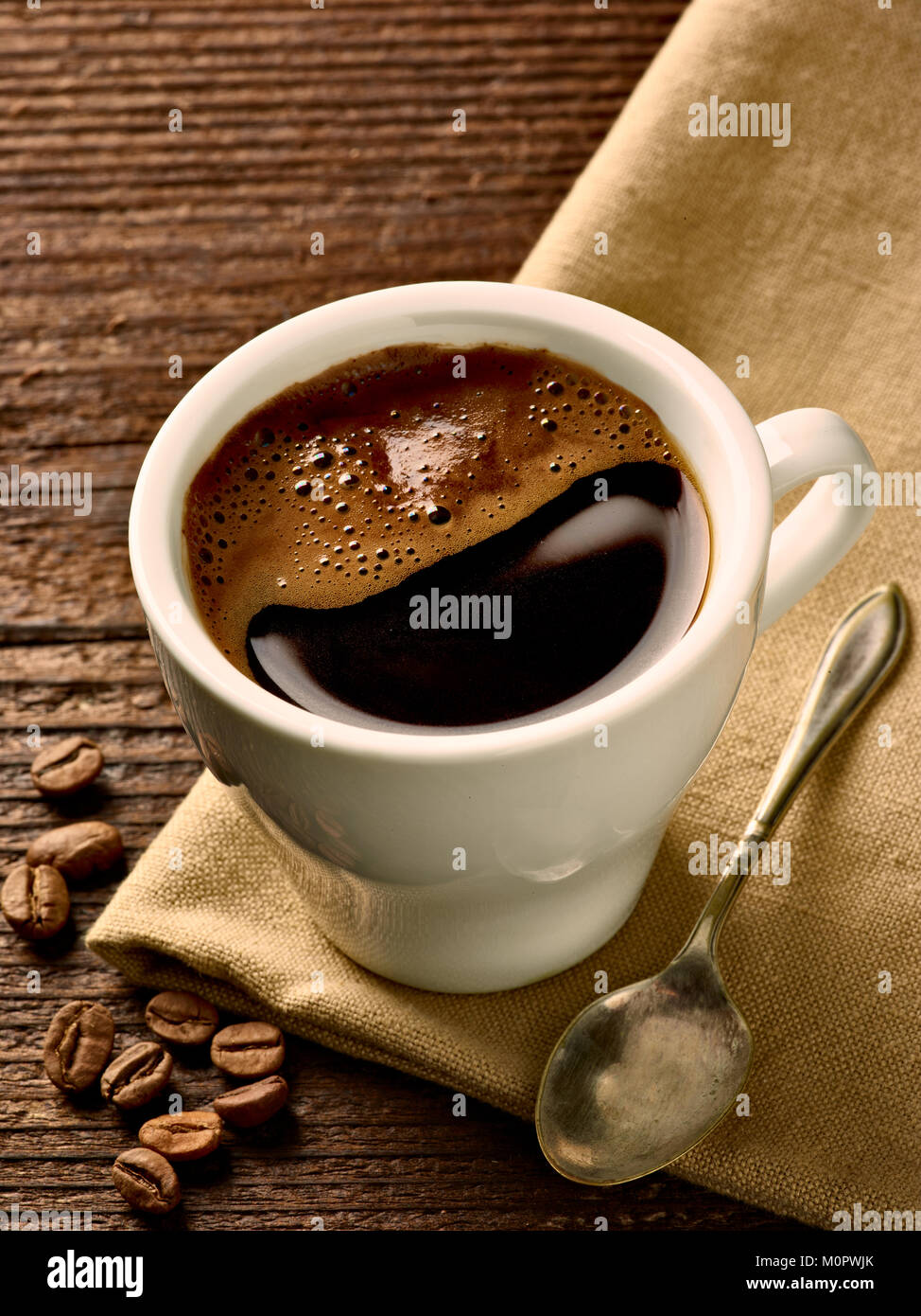 close up of a coffee cup on wooden background Stock Photo - Alamy
