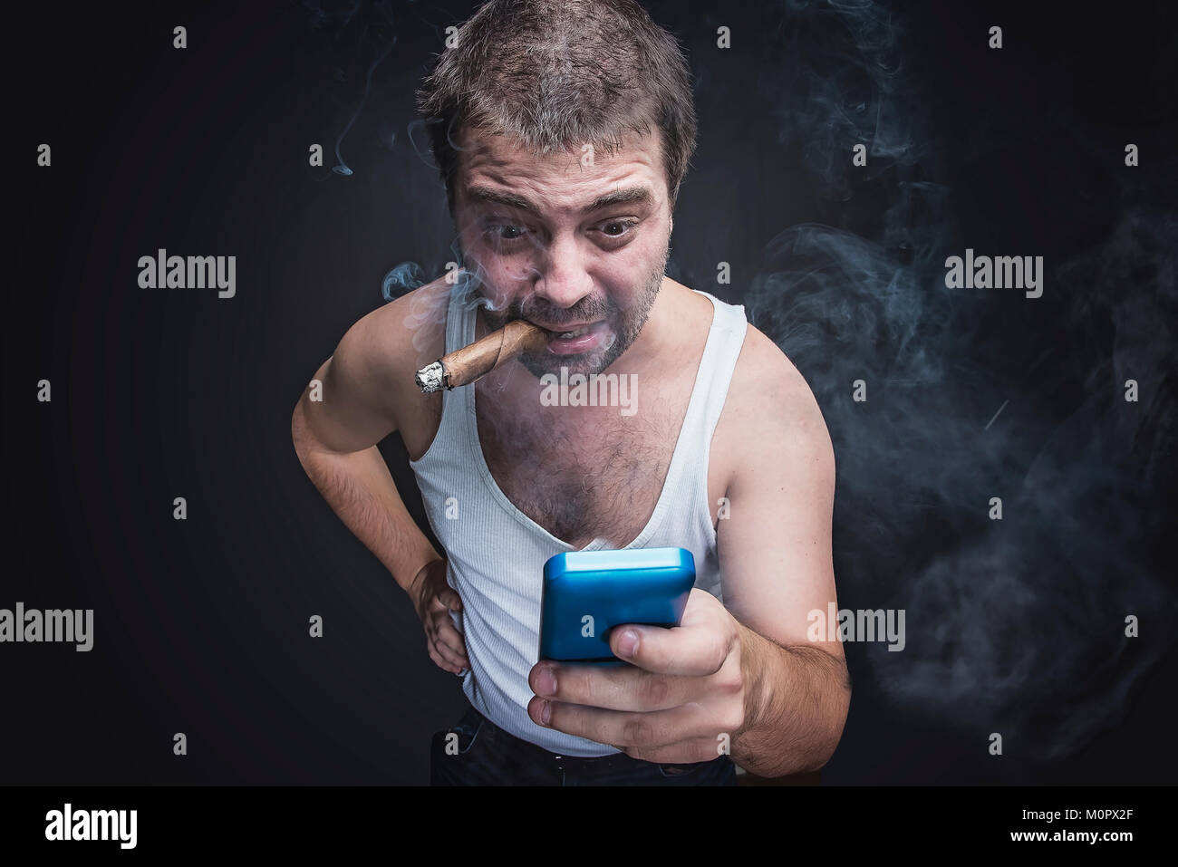 Rude smoking man yelling at his cell phone Stock Photo - Alamy