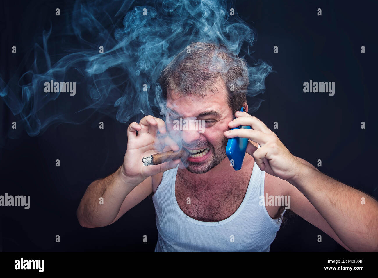 Rude smoking man yelling at his cell phone Stock Photo - Alamy