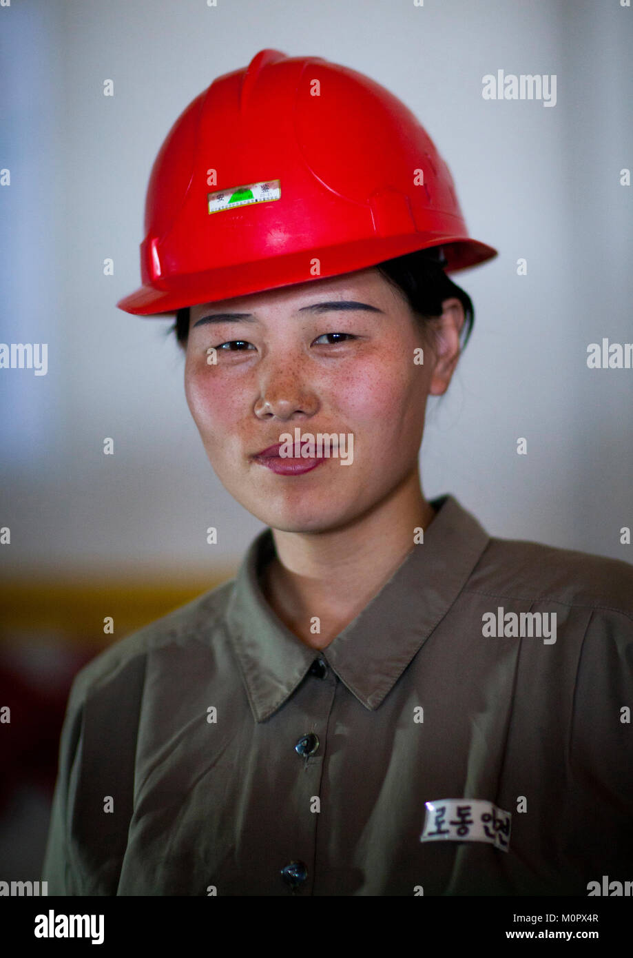 North Korean worker woman wearing a red helmet in a factory, South ...