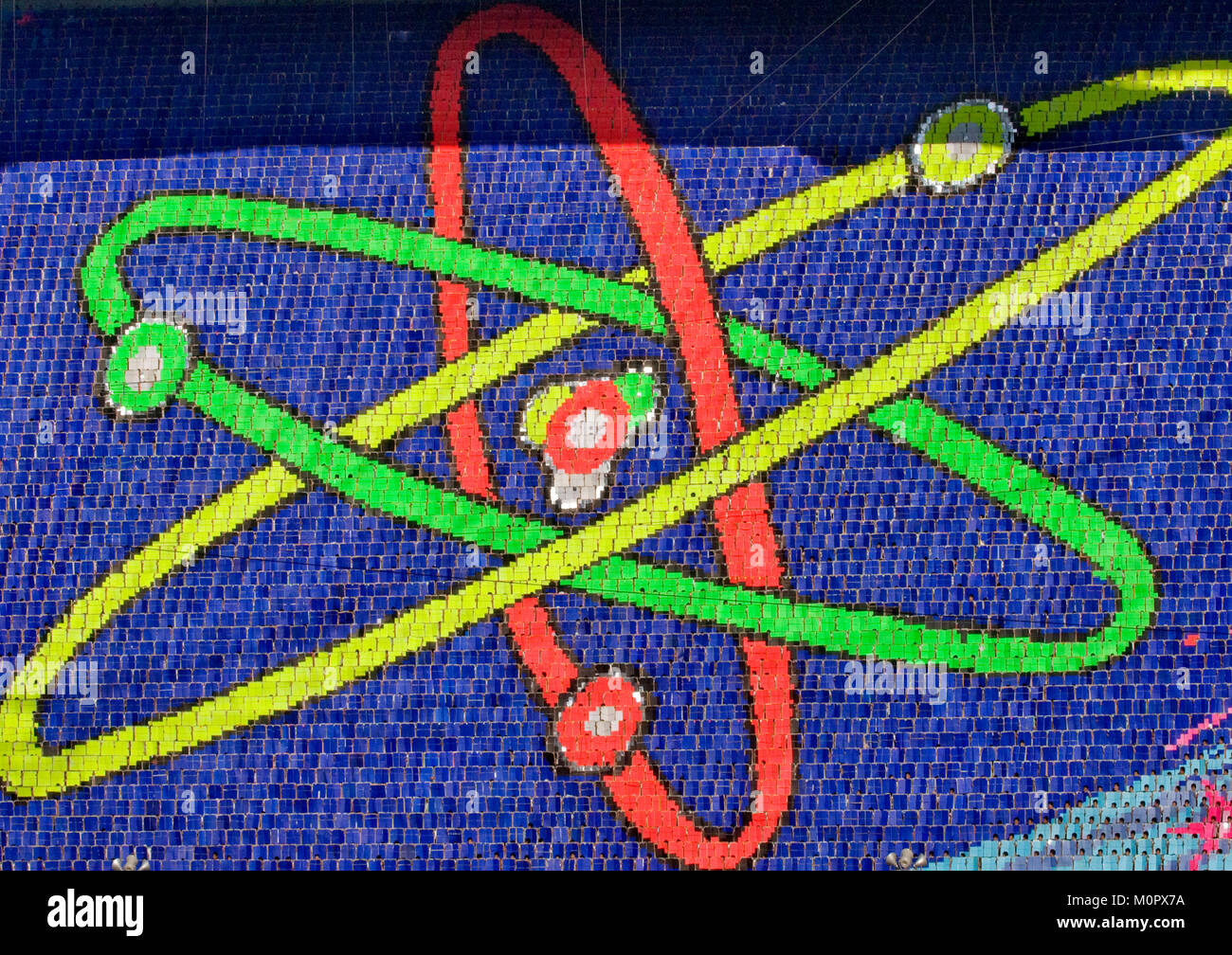 Nuclear atom made by children pixels holding up colored boards during ...