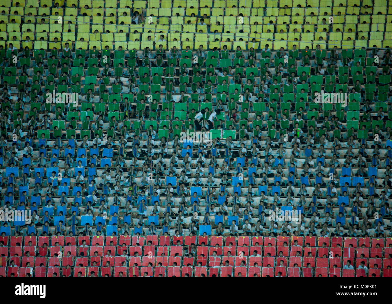 Children used to make human pixels by holding up colored boards during ...