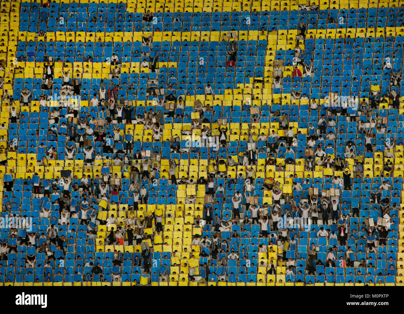 Children used to make human pixels by holding up colored boards during ...