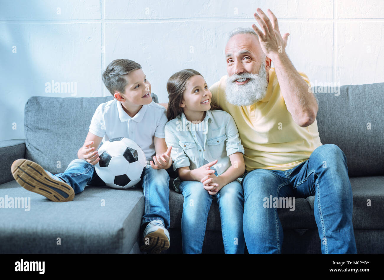 Excited grandfather telling children interesting story Stock Photo - Alamy