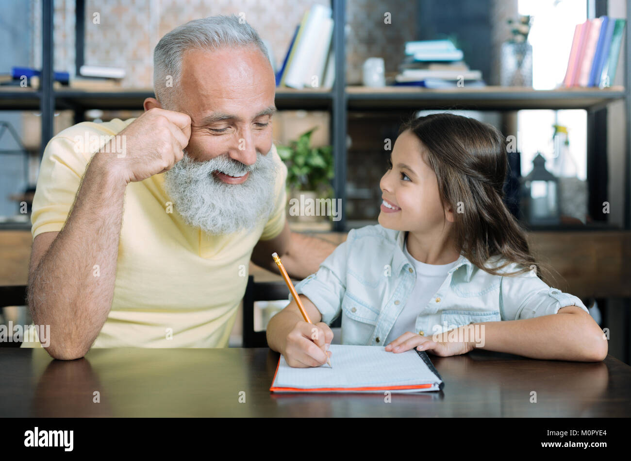 Child helping elderly hi-res stock photography and images - Alamy
