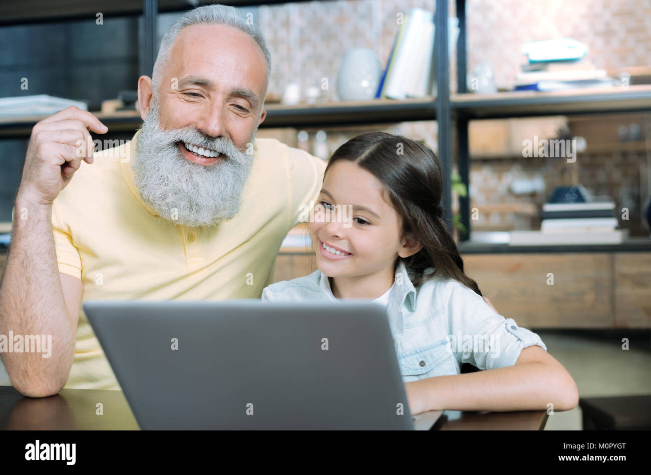 Joyful two generations of family using laptop together Stock Photo - Alamy