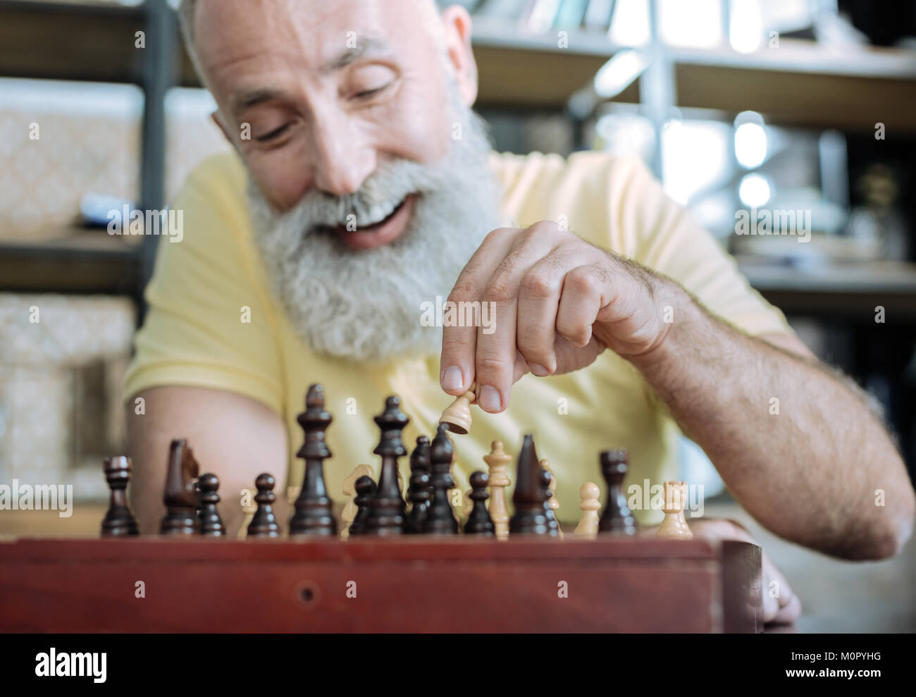 Extremely happy senior man playing chess at home Stock Photo - Alamy